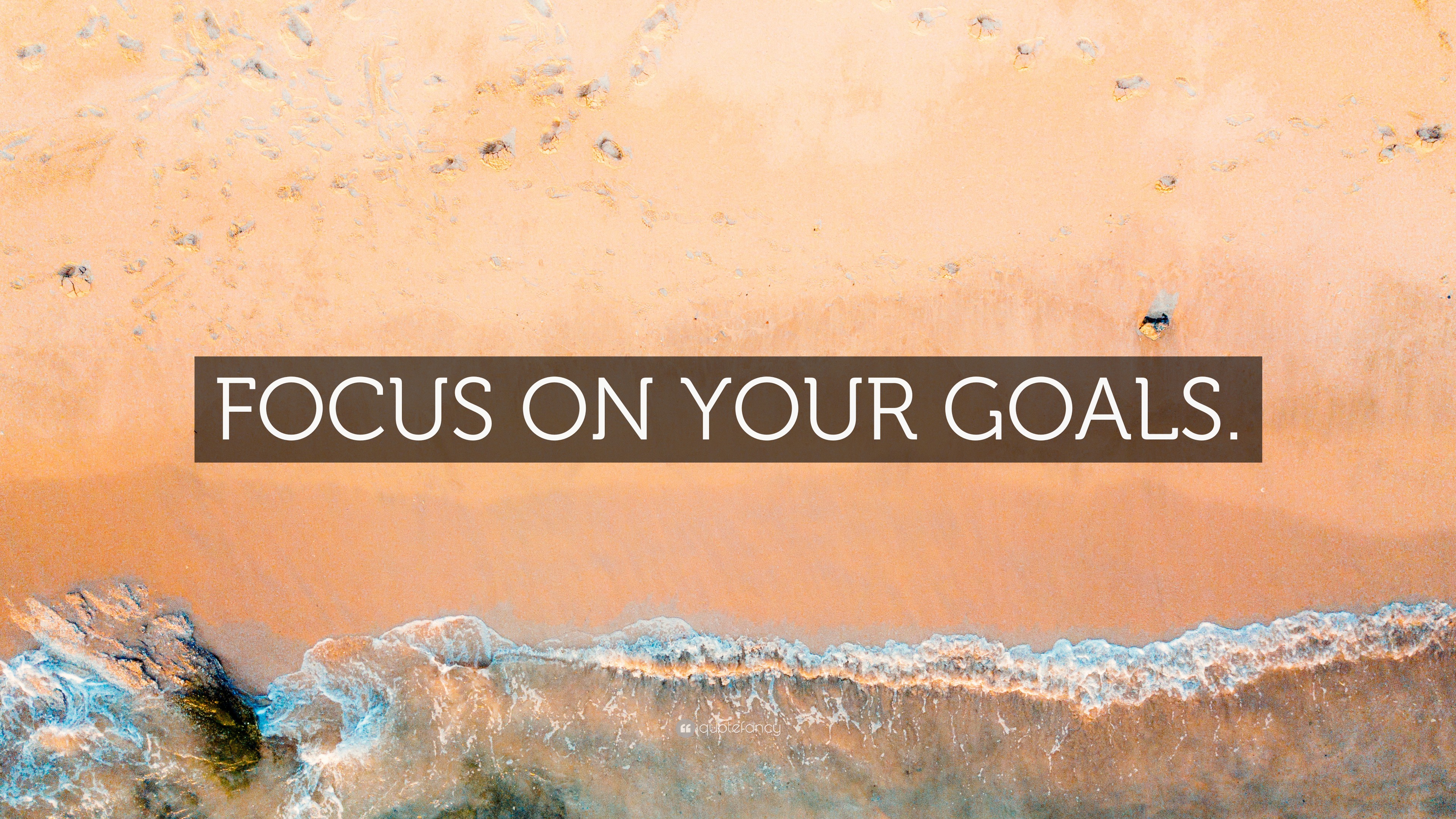 “FOCUS ON YOUR GOALS.” Wallpaper by QuoteFancy